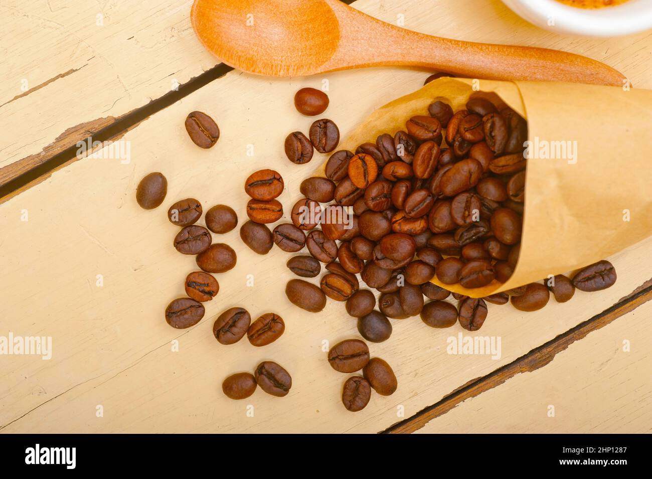 espresso coffee and beans on a paper cone cornucopia over white ...