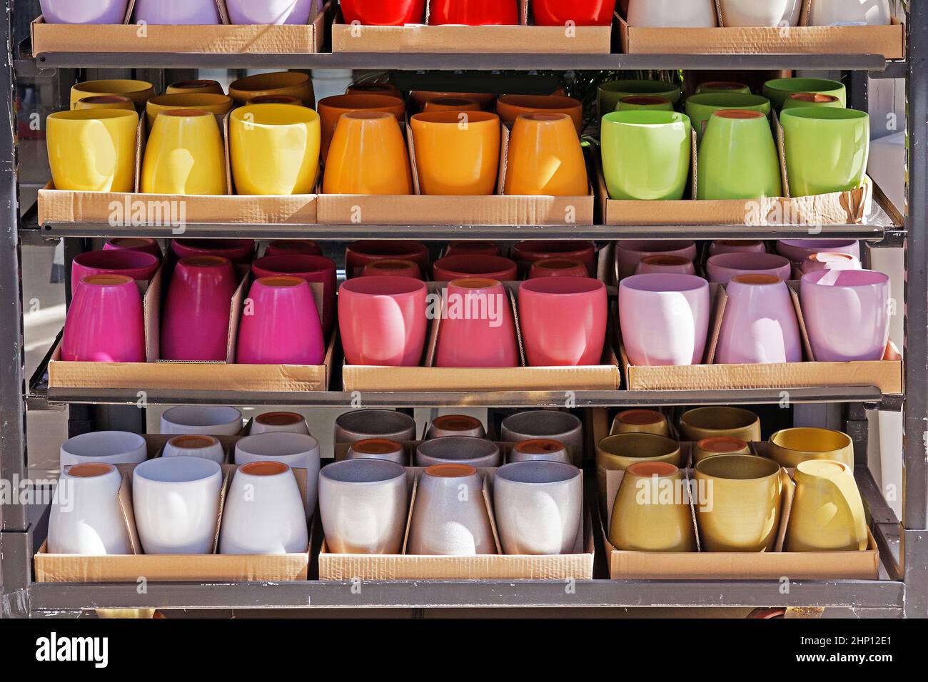 Colorful ceramic flower pots on shelves sold on market stall Stock ...