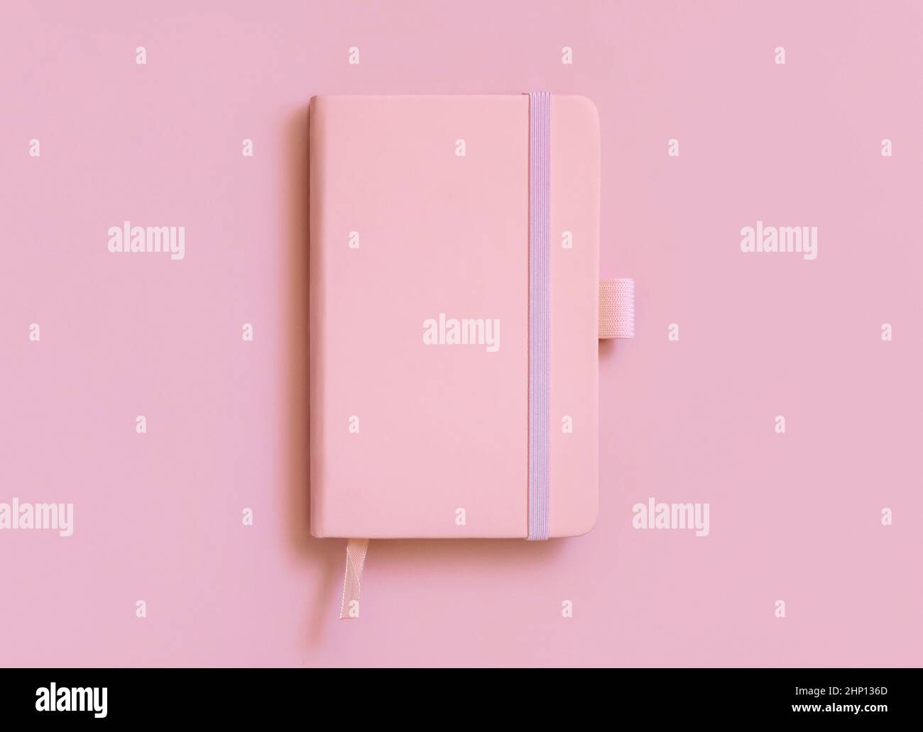 Pink hardcover notebook on light pink top view. Textbook cover mockup ...