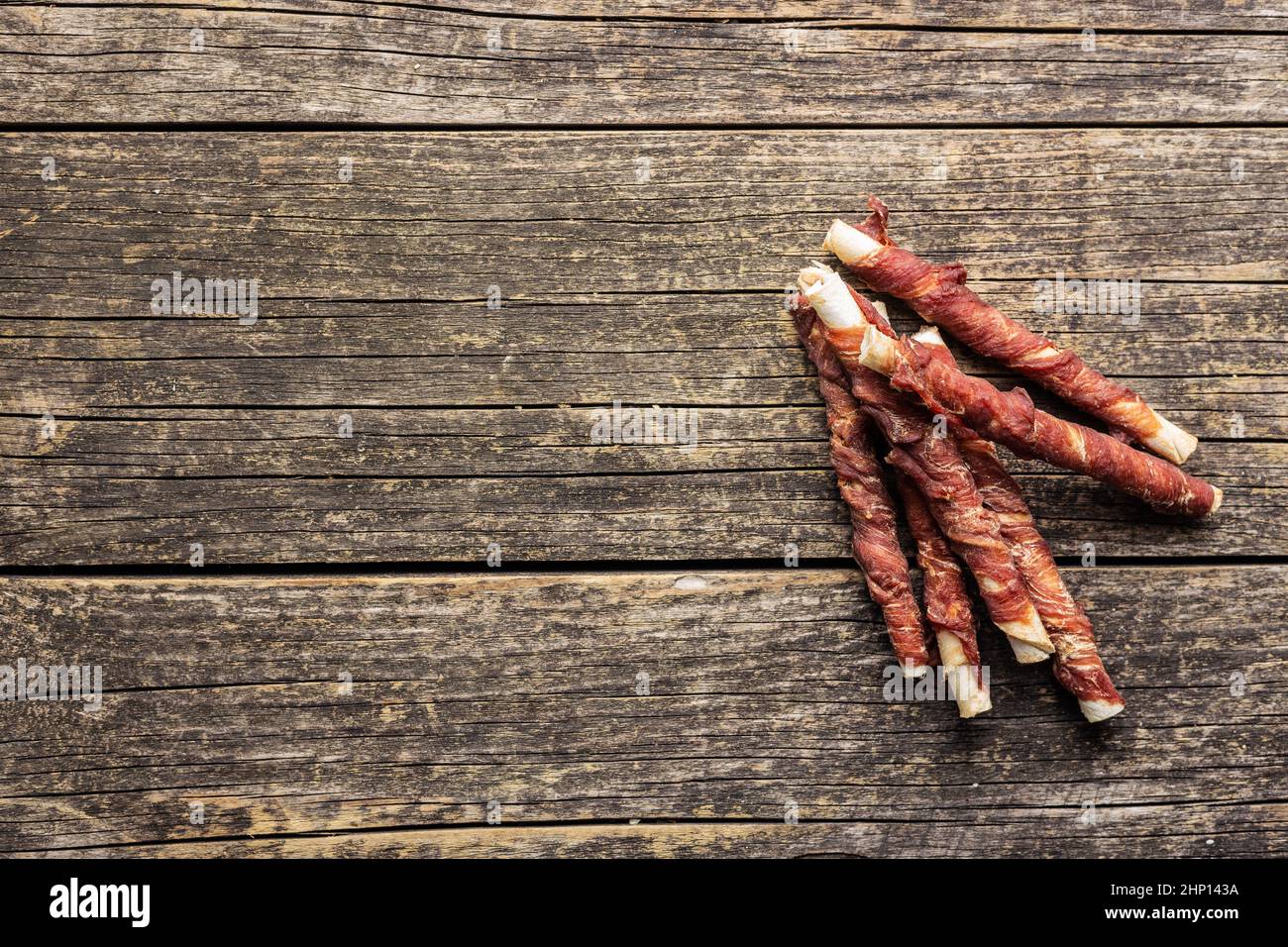 Dog treat sticks. Chewy sticks for dog on wooden table. Top view Stock ...