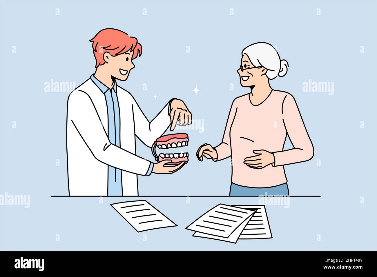 Male doctor consult old woman patient about teeth prosthesis in dental ...