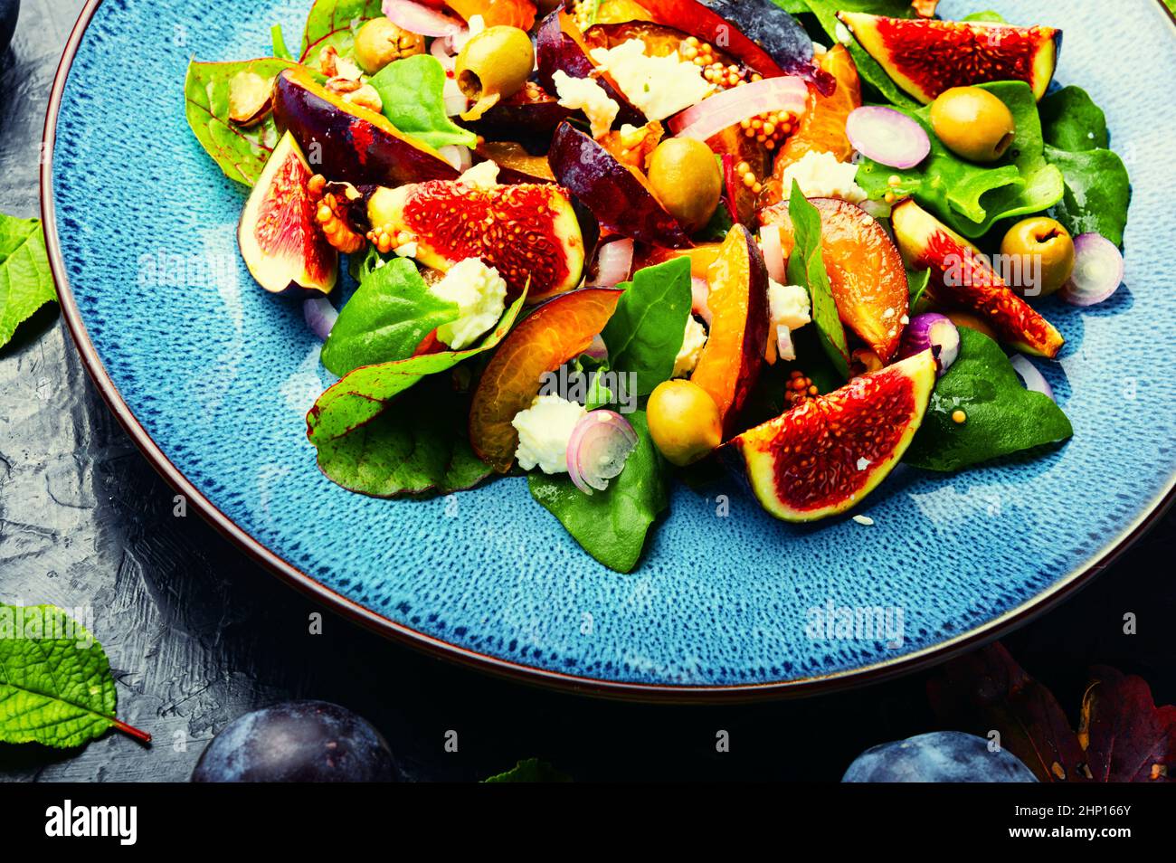 Autumn salad with plums,figs,olives and cheese.Autumn salad of fruits ...