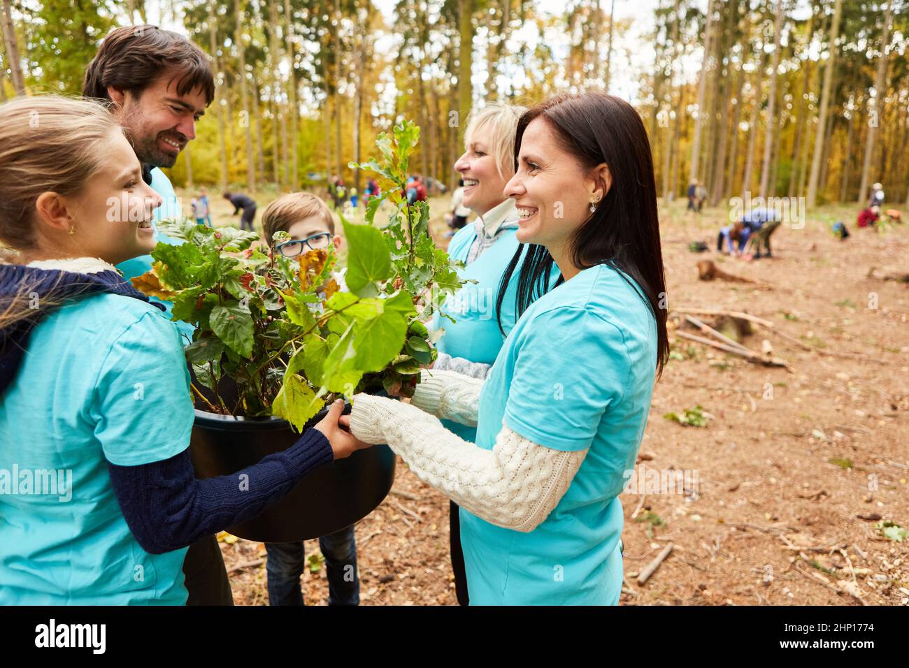 Family and two children at a voluntary reforestation campaign for ...