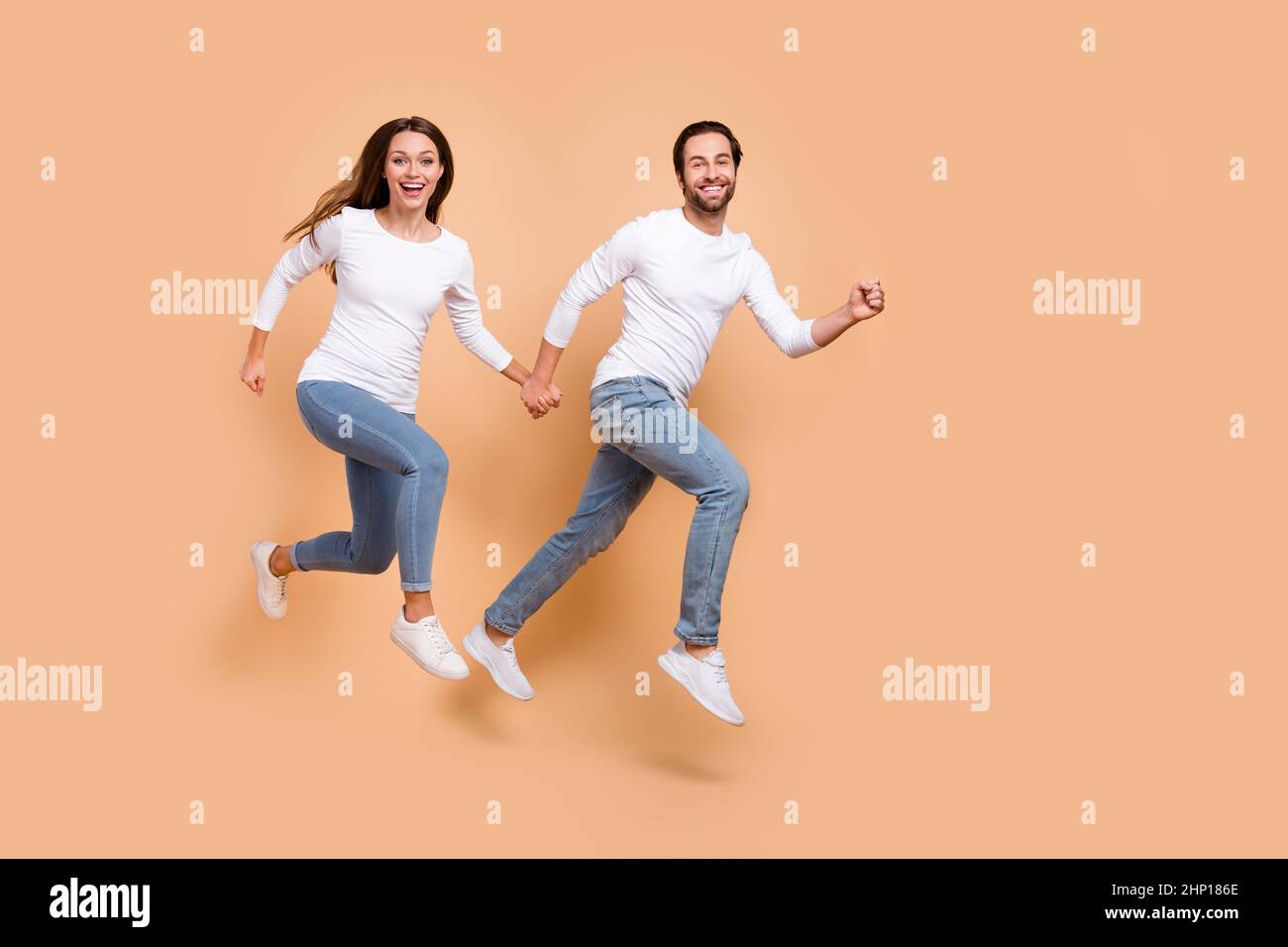 Full length body size view of attractive cheerful partners jumping ...