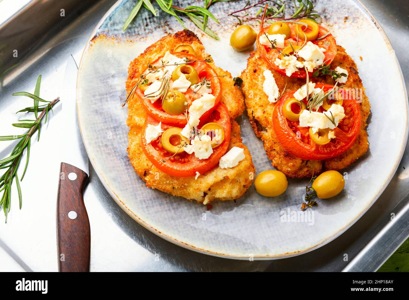 Schnitzel, breaded and fried thin layer of meat. Cretan schnitzel Stock ...