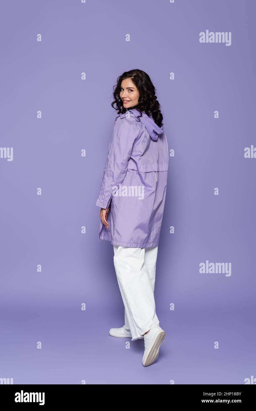 Woman in purple raincoat hi-res stock photography and images - Alamy