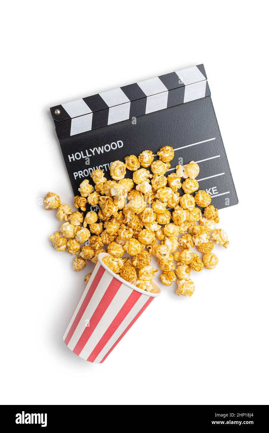Sweet caramel popcorn and clapper board isolated on white background ...