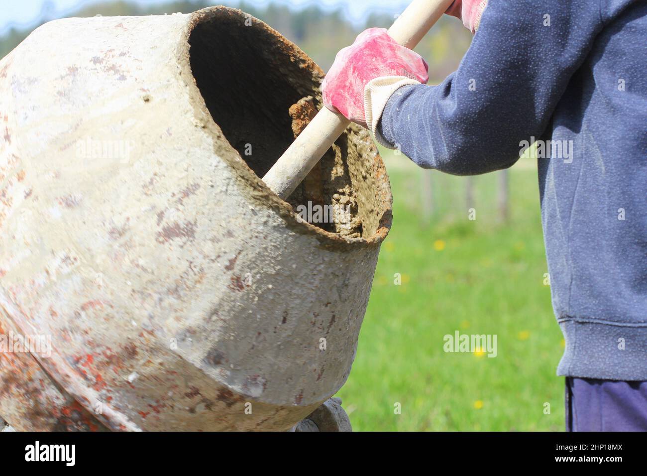 Construction worker mixing ingredients in the concrete mixer at ...