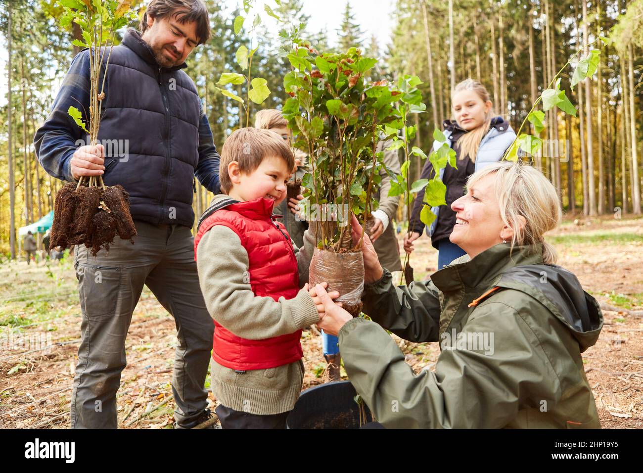 Family and children together in reforestation campaign for ...