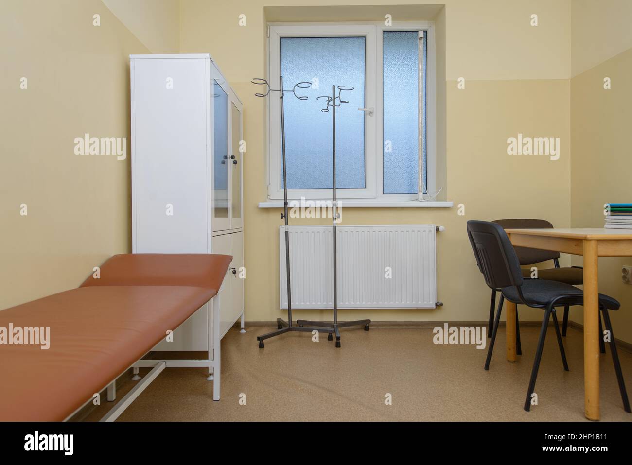 Empty poor looking doctor's office. white medical cabinet Stock Photo ...