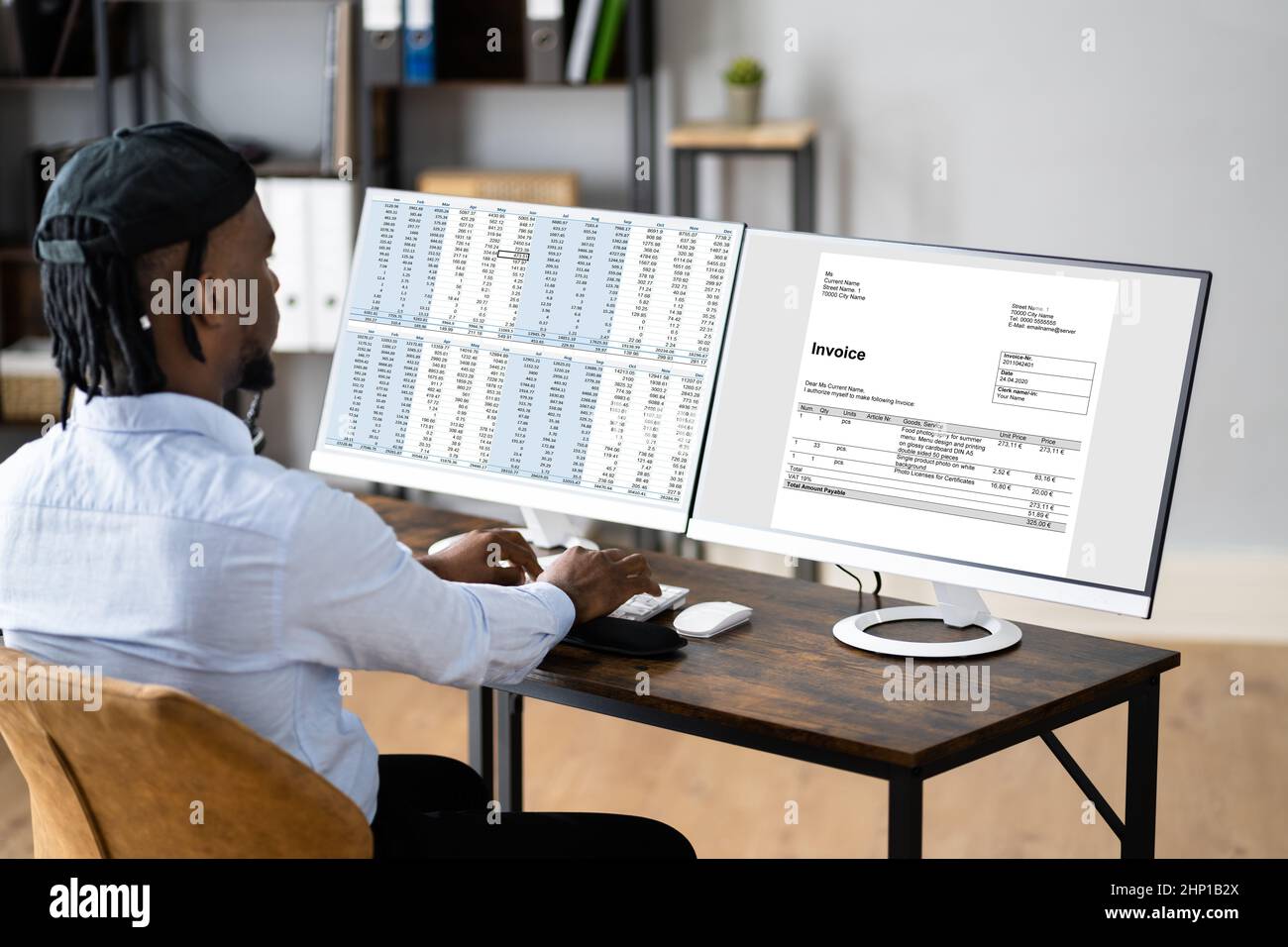Looking At Invoice And Spreadsheet On Computer At Work Stock Photo - Alamy