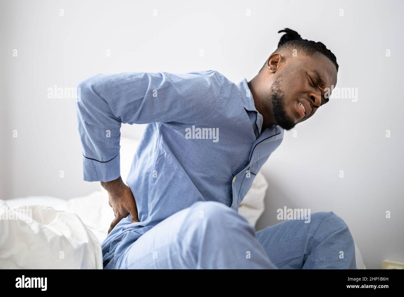 Casual african man back pain hi-res stock photography and images - Alamy