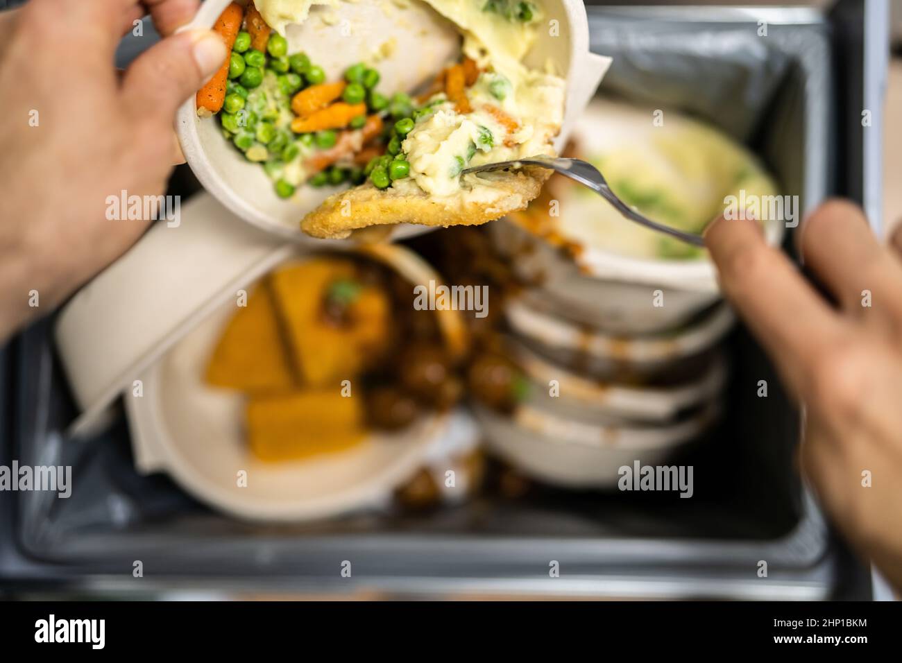Throwing Away Leftover Food In Trash Or Garbage Dustbin Stock Photo - Alamy
