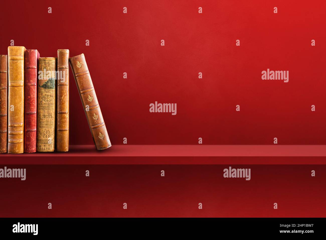 Row of old books on red shelf. Horizontal background scene Stock Photo ...
