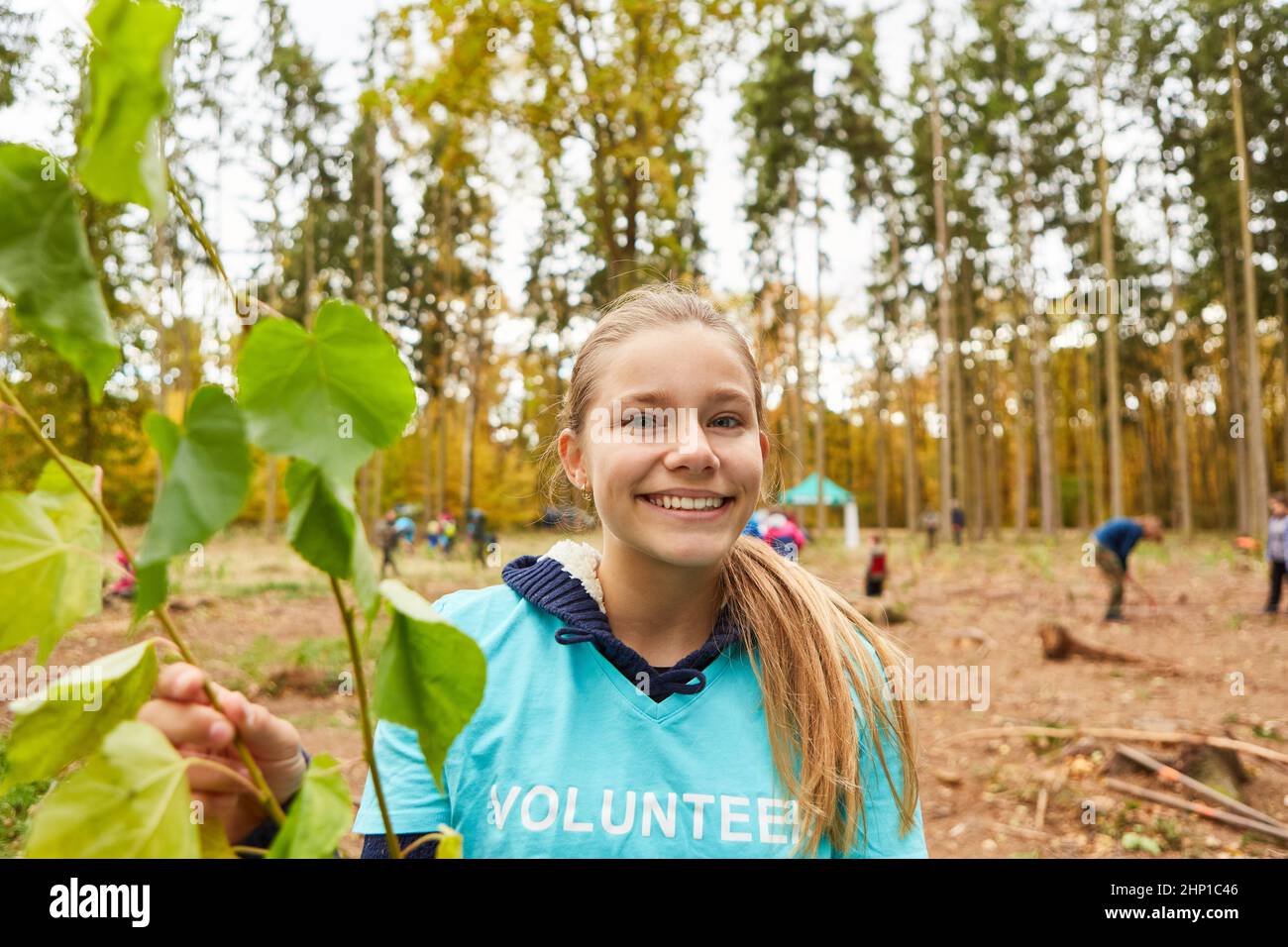 Happy girl as a volunteer in the sustainable reforestation campaign in ...