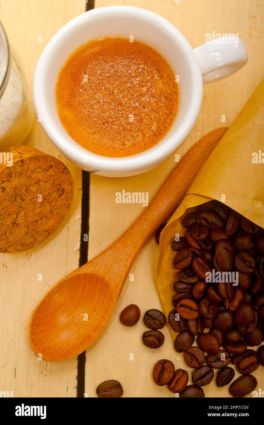 espresso coffee and beans on a paper cone cornucopia over white ...