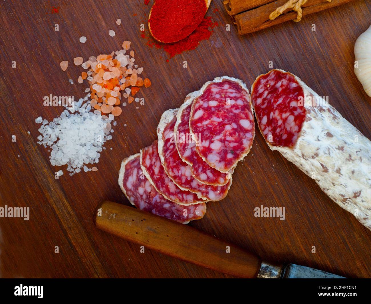 traditional Italian salame cured sausage sliced on a wood board Stock ...