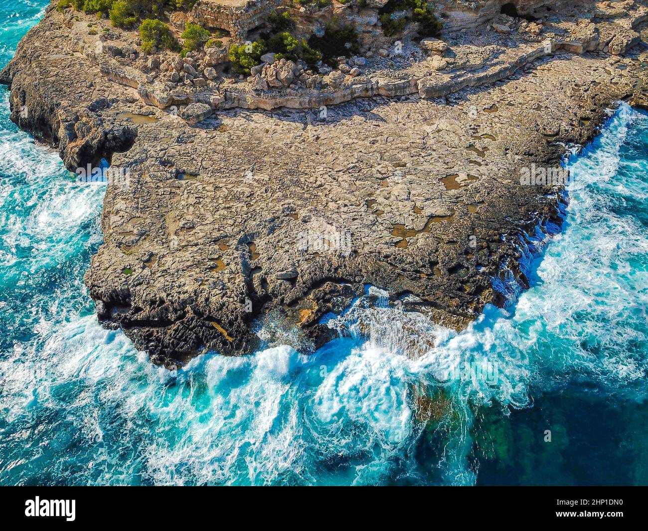 Drone above bay and Punta de Sa Guardia of Cala Mondrago Samarador in ...