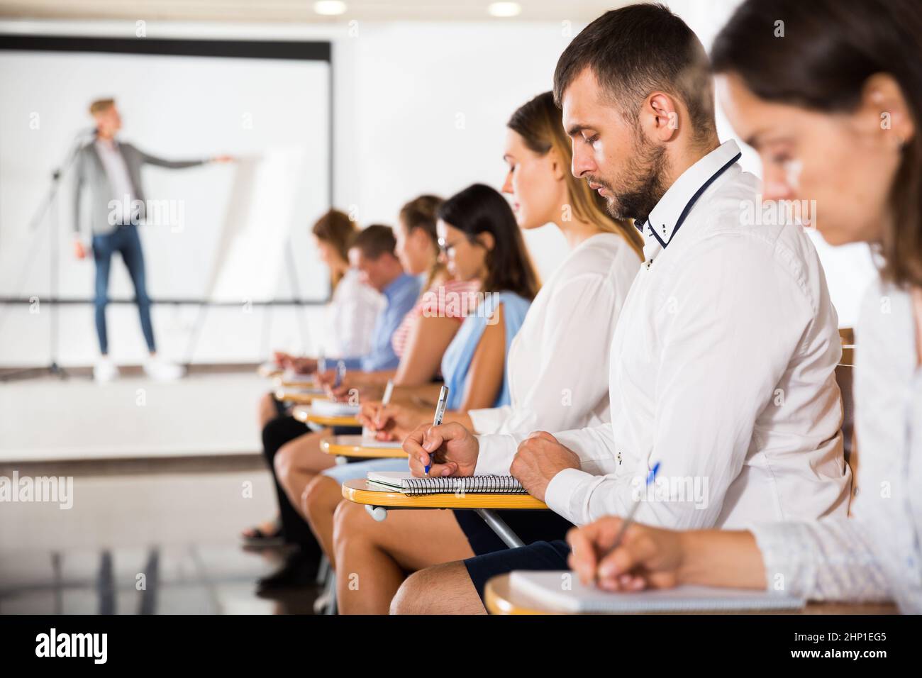 Side view of student group on lecture Stock Photo - Alamy