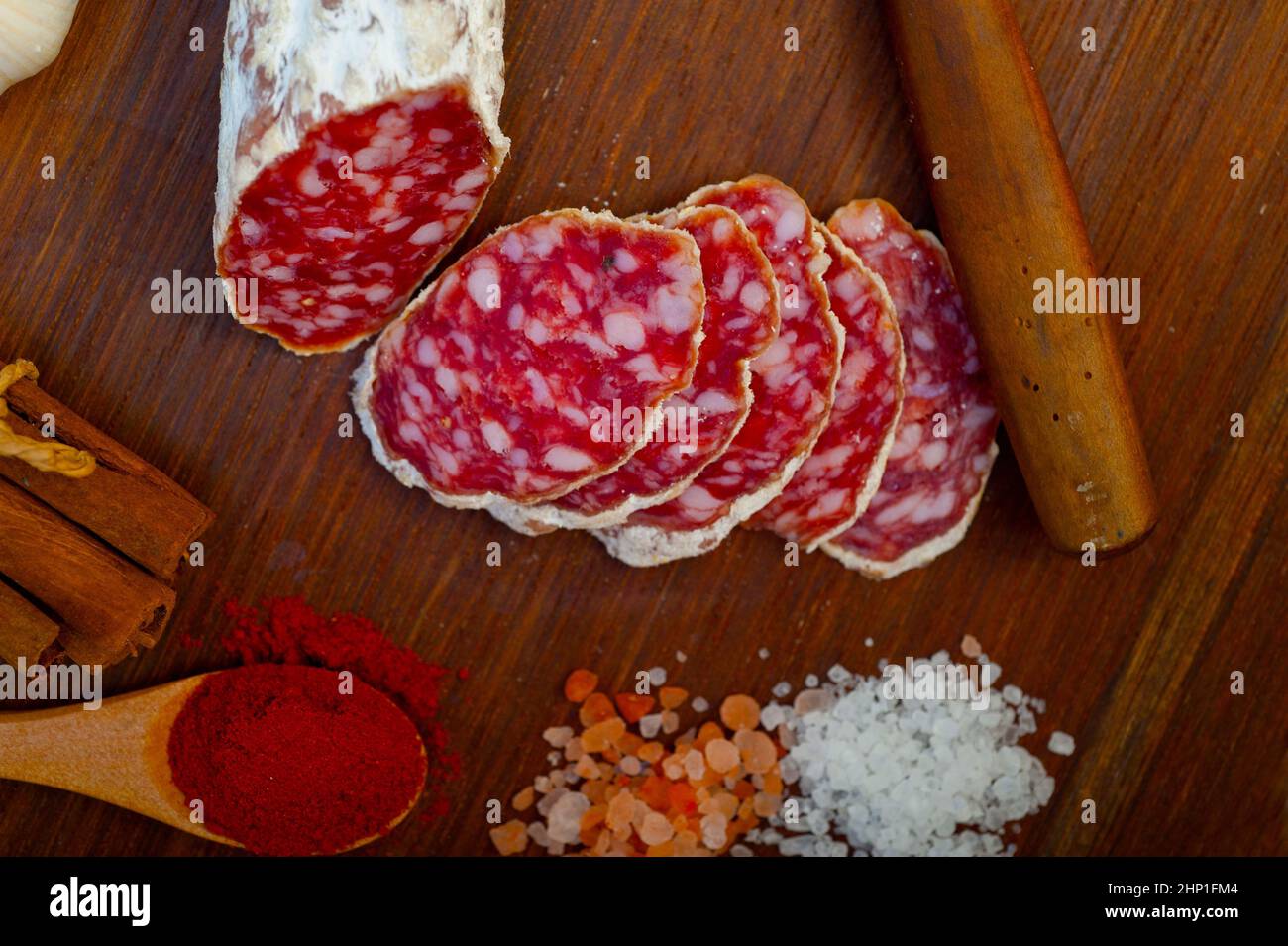 traditional Italian salame cured sausage sliced on a wood board Stock ...