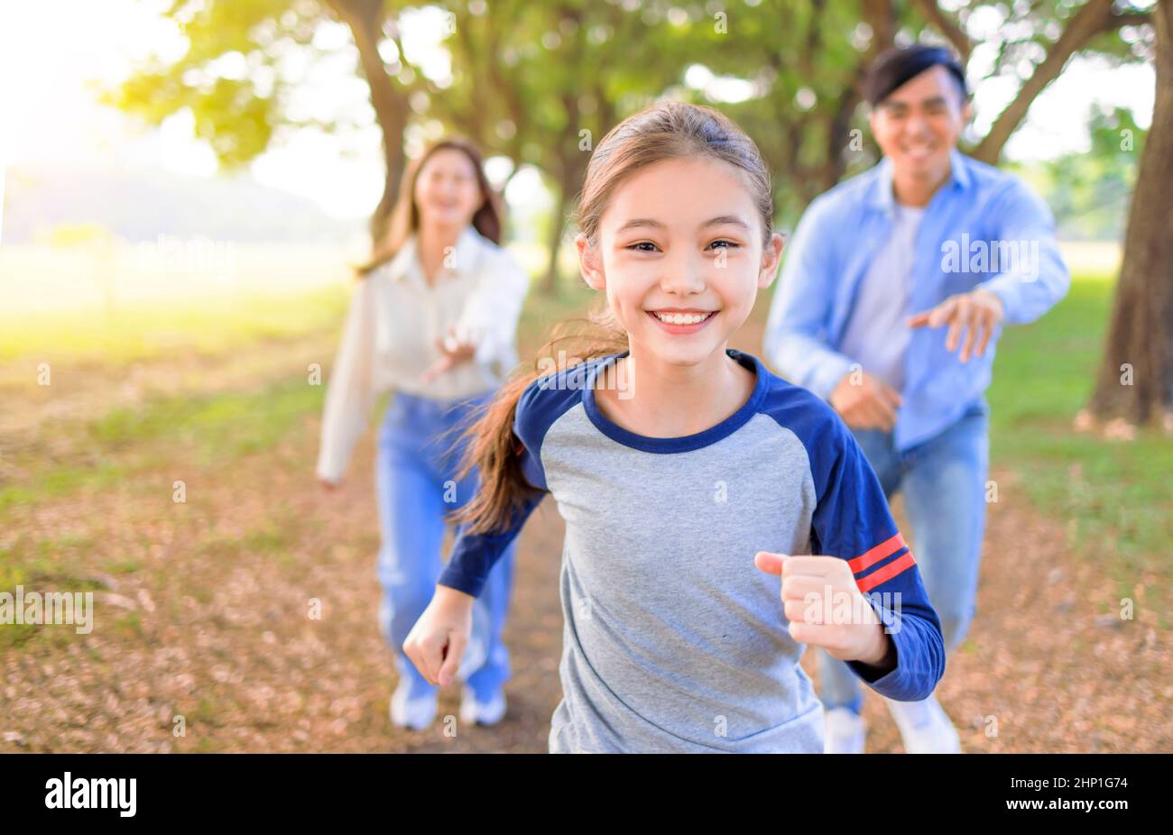 Happy Family with daughter running and playing together in the park ...