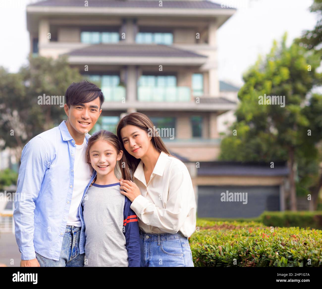 Happy asian family stand outside before their new house Stock Photo - Alamy