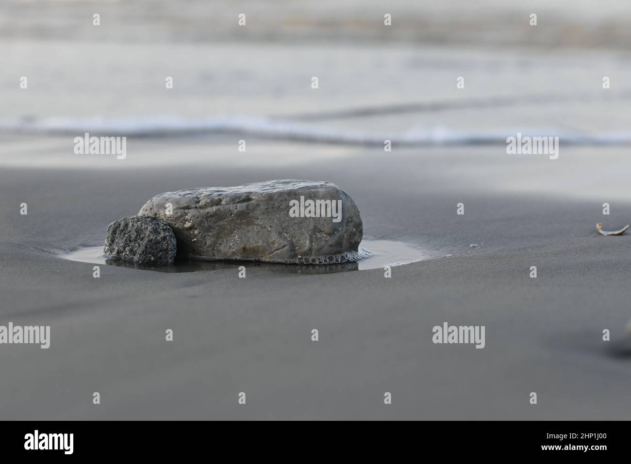 Stone on the beach washed by sea water Stock Photo - Alamy