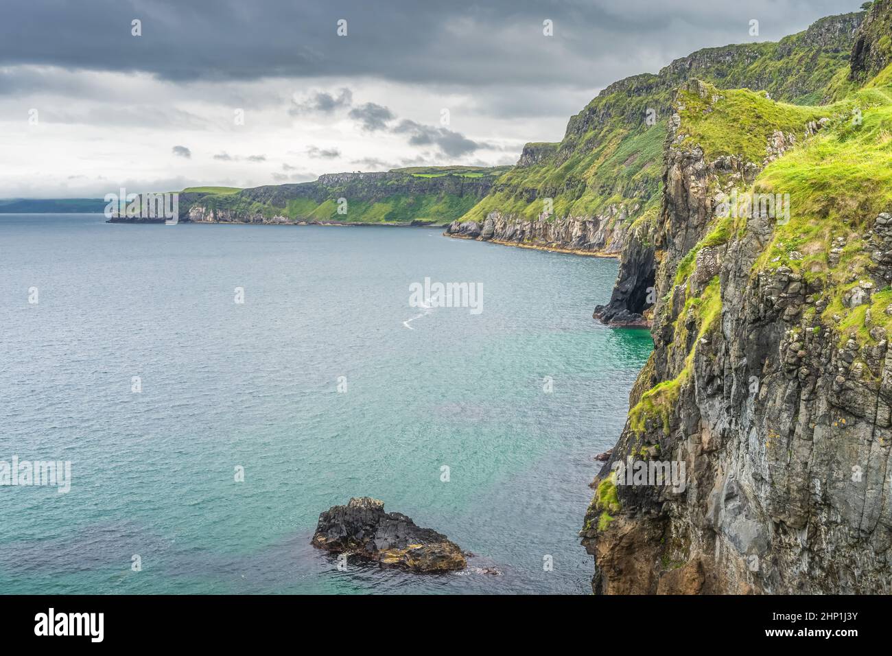 Coastline with tall limestone cliffs, Rathlin Island and turquoise ...