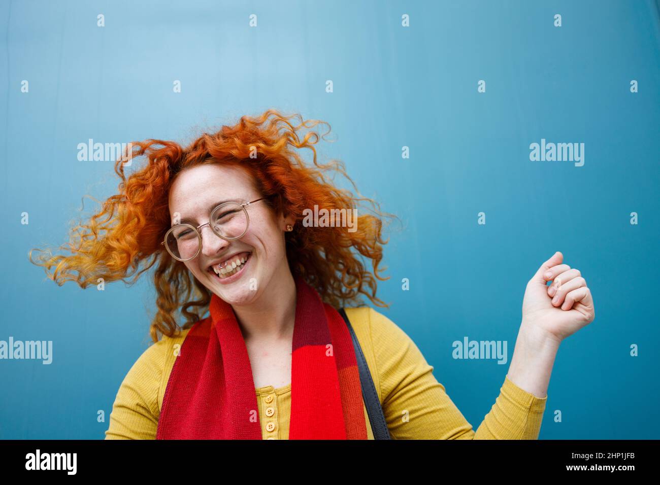 Portrait of a young woman dancing and smiling while dancing Stock Photo ...
