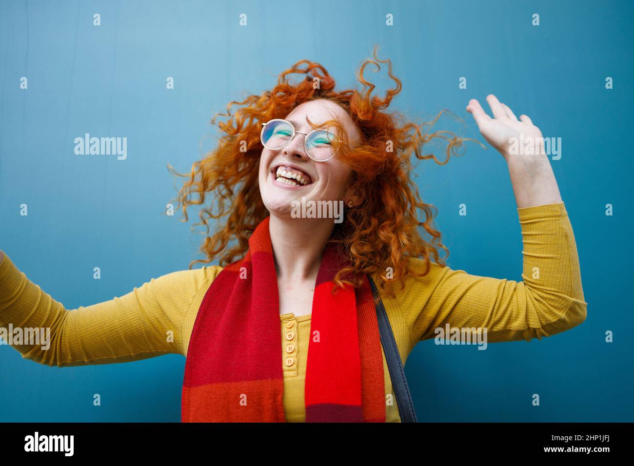 Happy curly woman enjoying her dance Stock Photo - Alamy