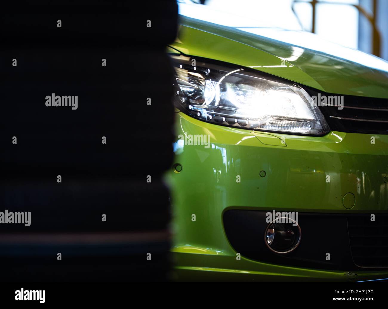 Car in a garage for maintenance, oil, tyre change (shallow DOF; color ...