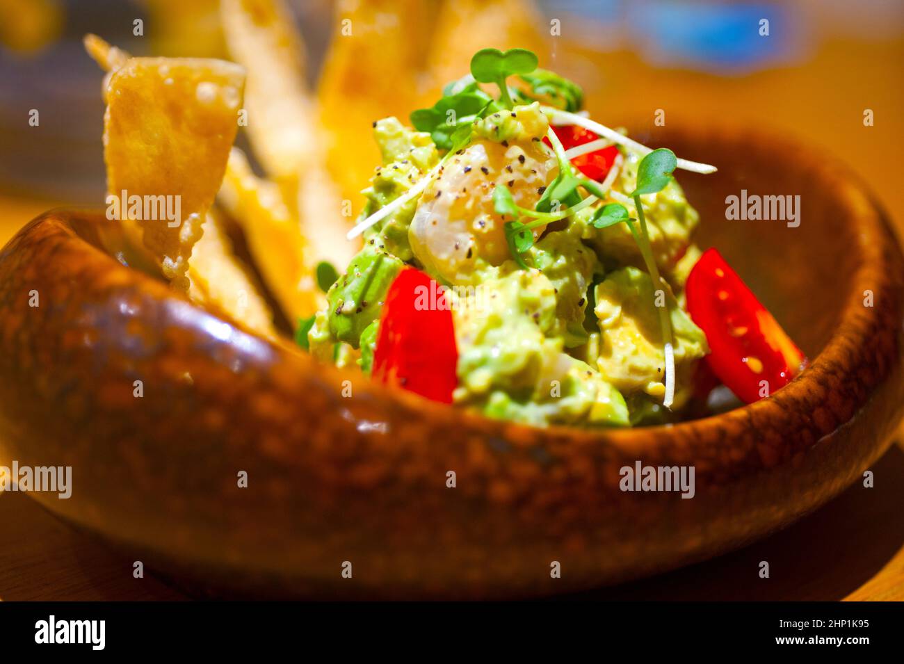 fresh avocado and shrimps salad with nachos on side Stock Photo - Alamy