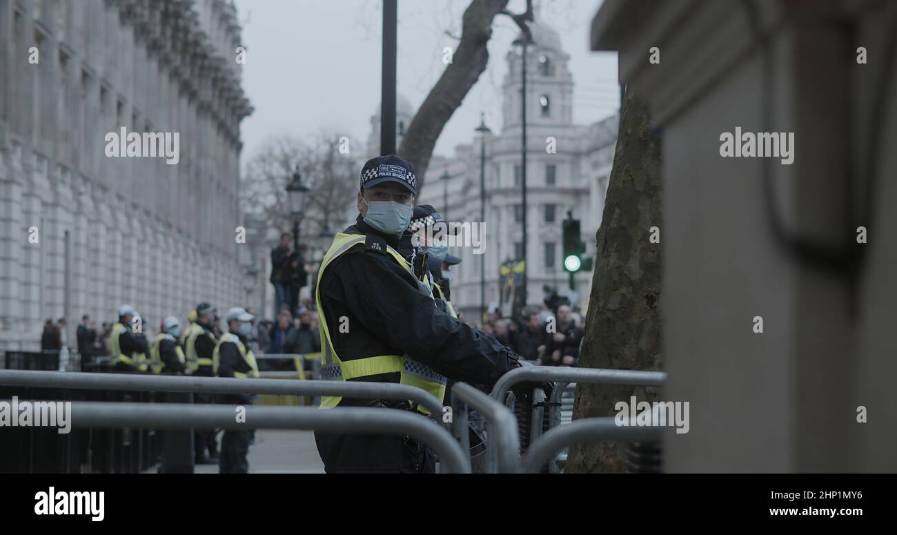 London, UK - 01 22 2022: A male police officer, standing in line on ...