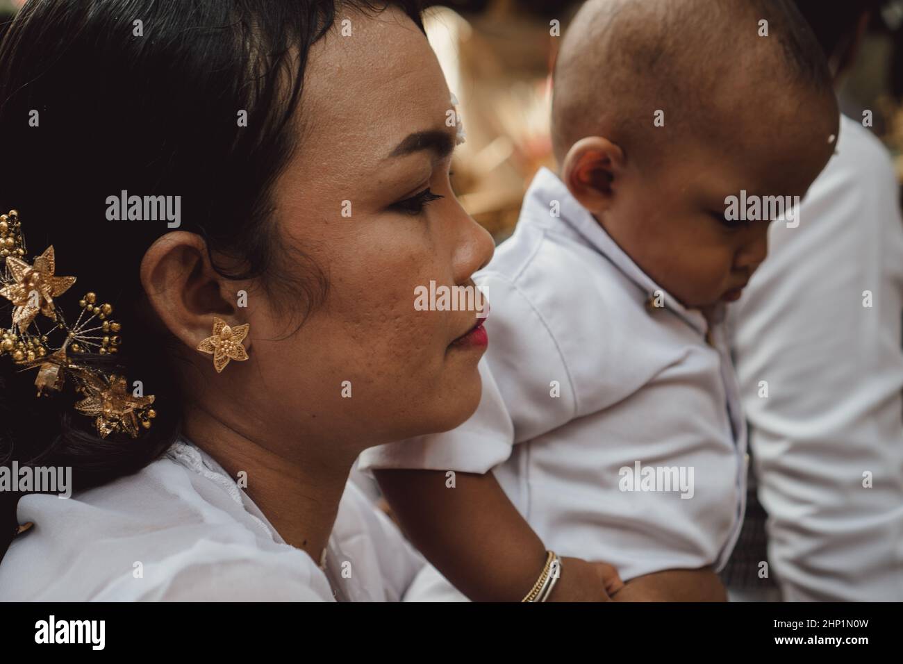 Balinese woman in traditional white clothes with a baby child Stock ...