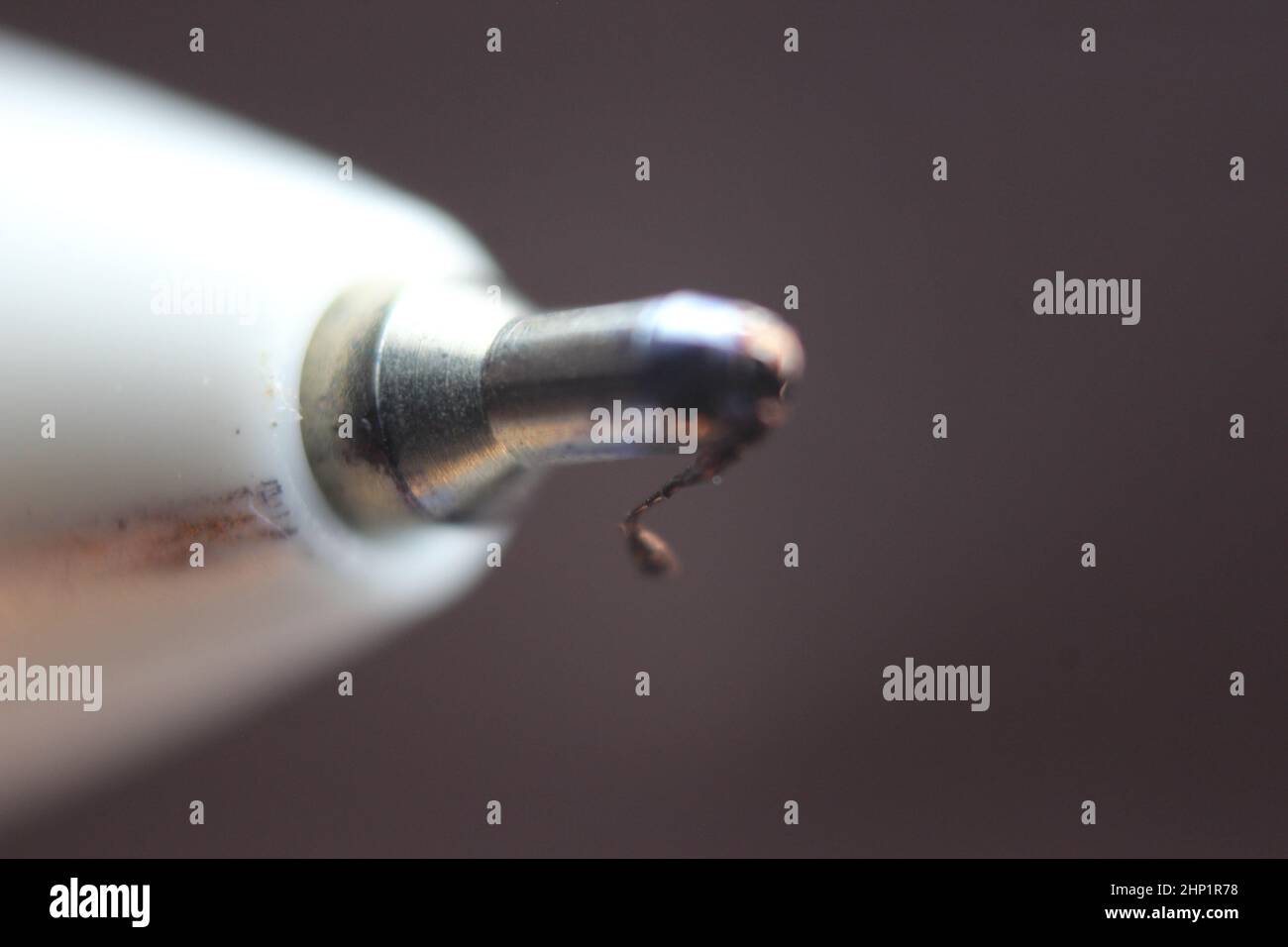 Macro photo of ballpoint pen tip with dark grey background. Extreme ...