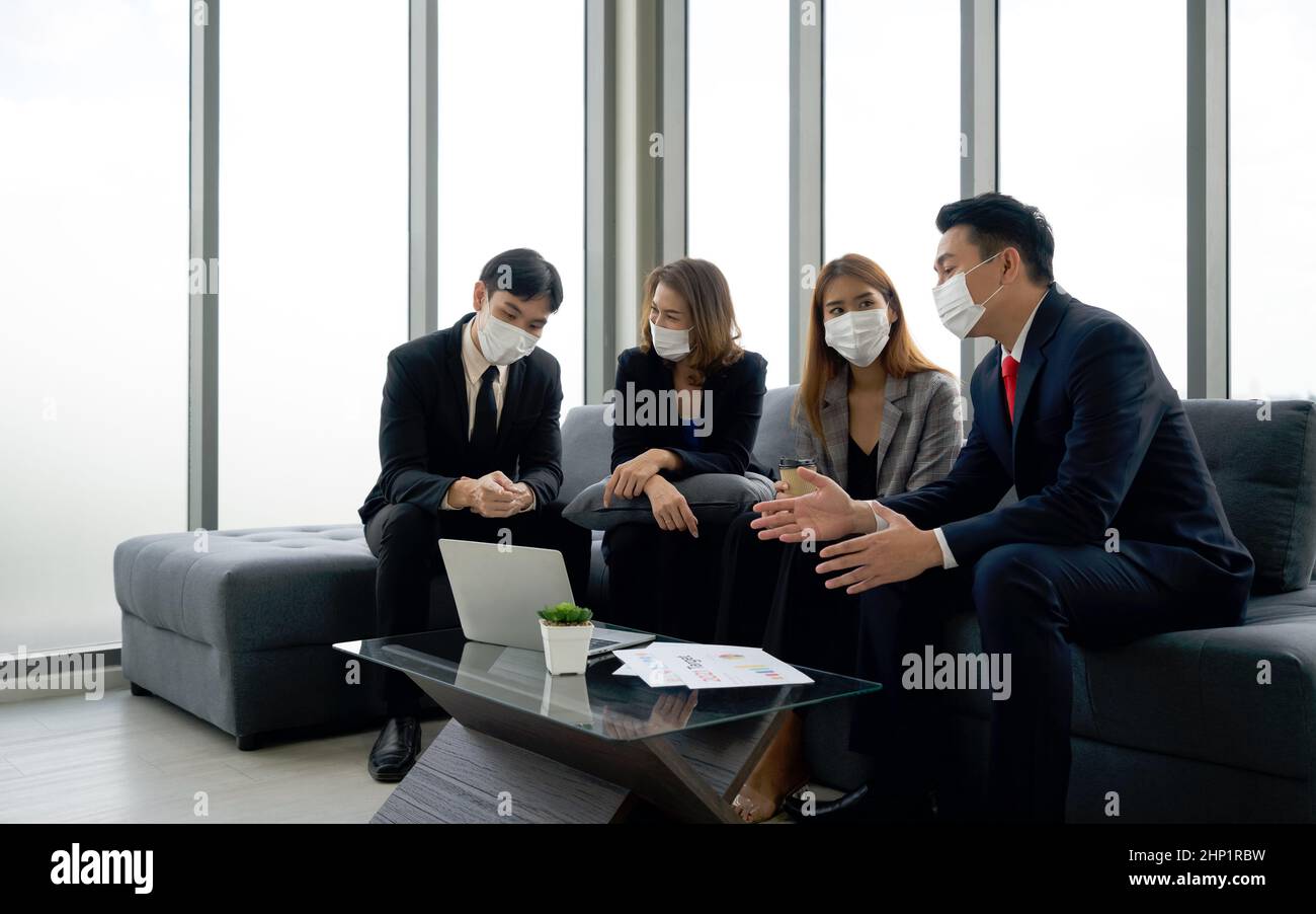 Group of business people in suit discuss about data on laptop computer ...