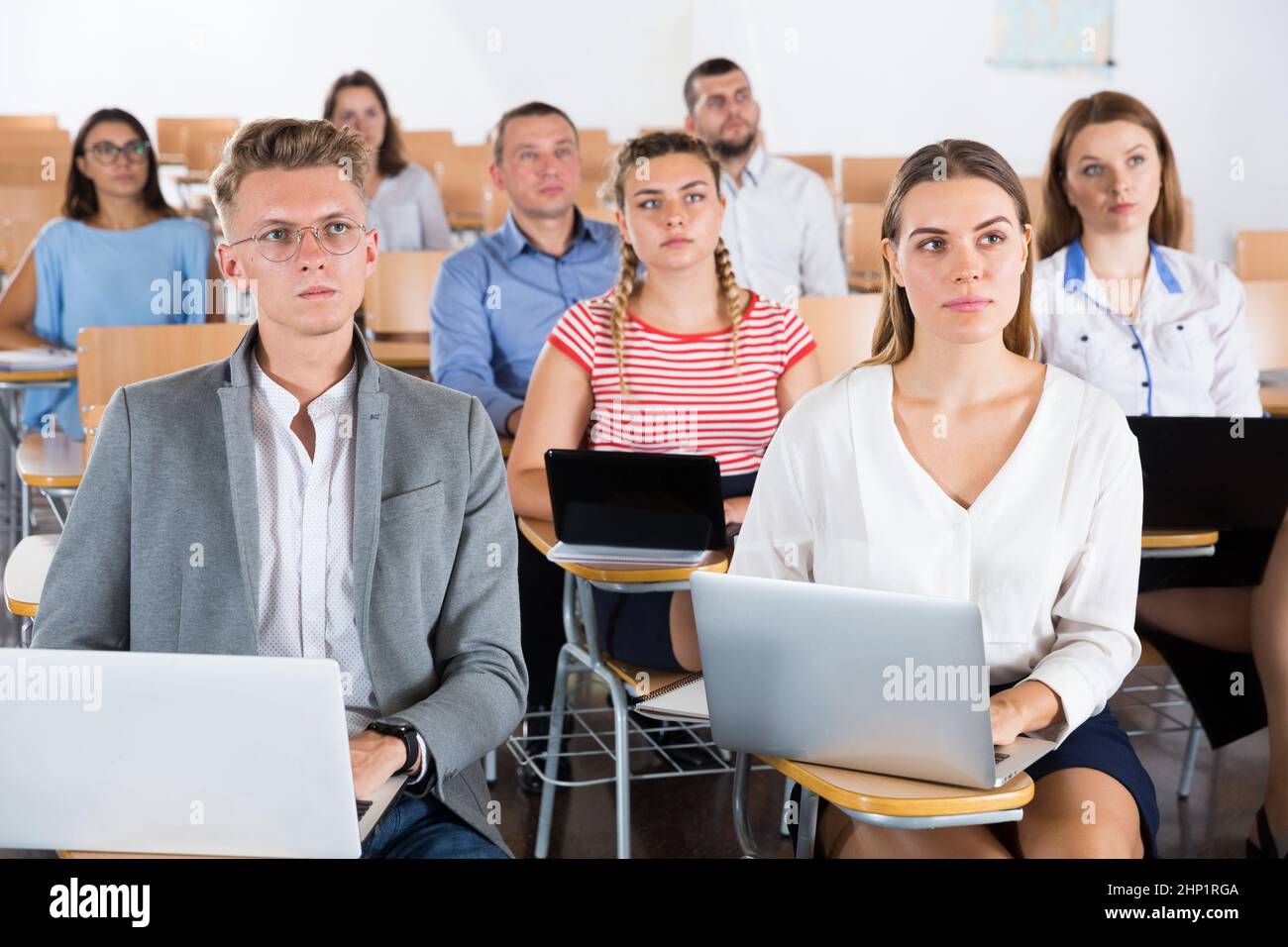 Group of people with laptops in lecture hall Stock Photo - Alamy