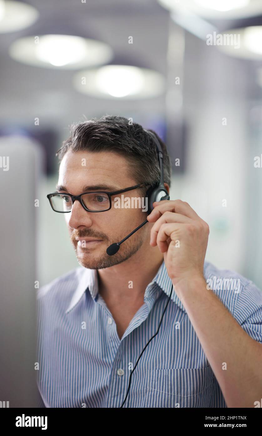 How can I help you. Cropped shot of a businessman wearing a headset ...