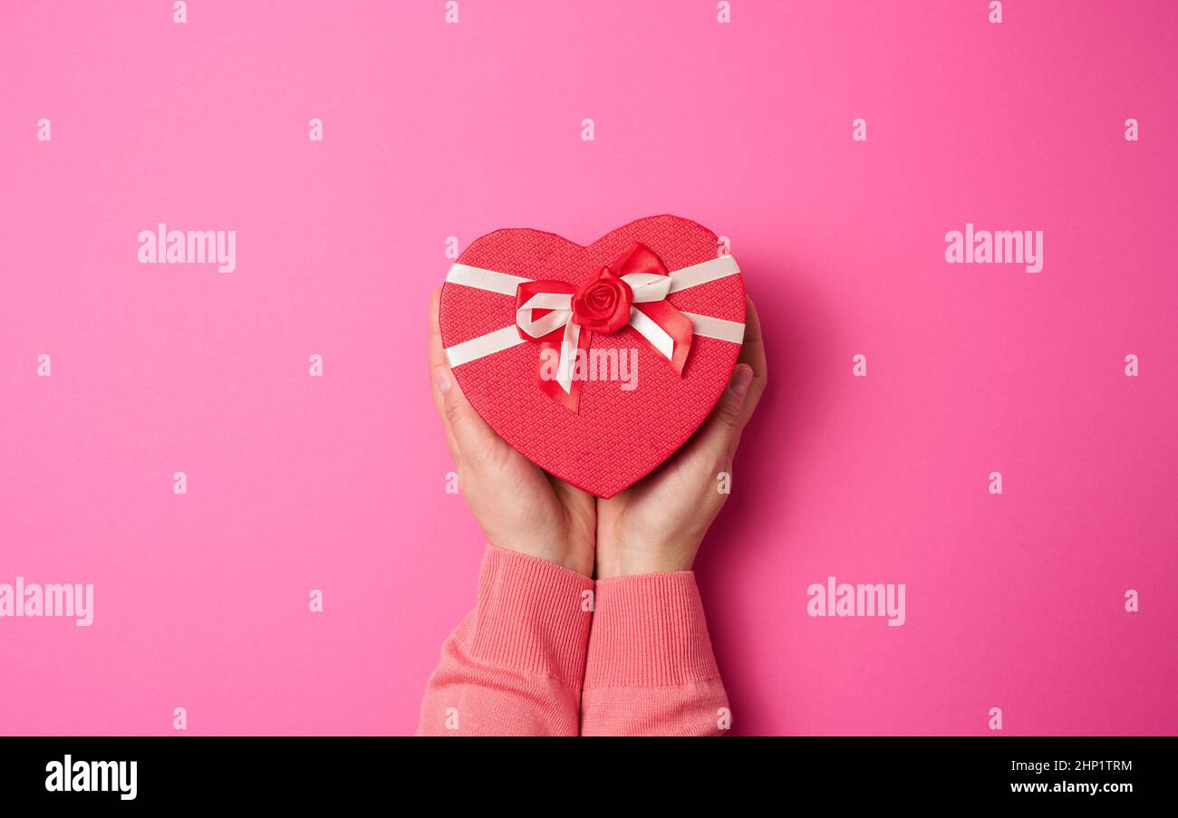 Hands hold a red heart hi-res stock photography and images - Alamy