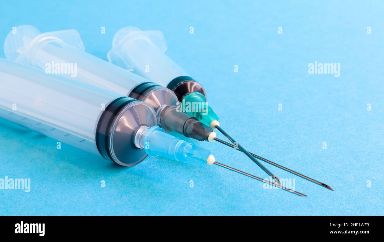 Three medical disposable plastic empty syringes with needles of ...