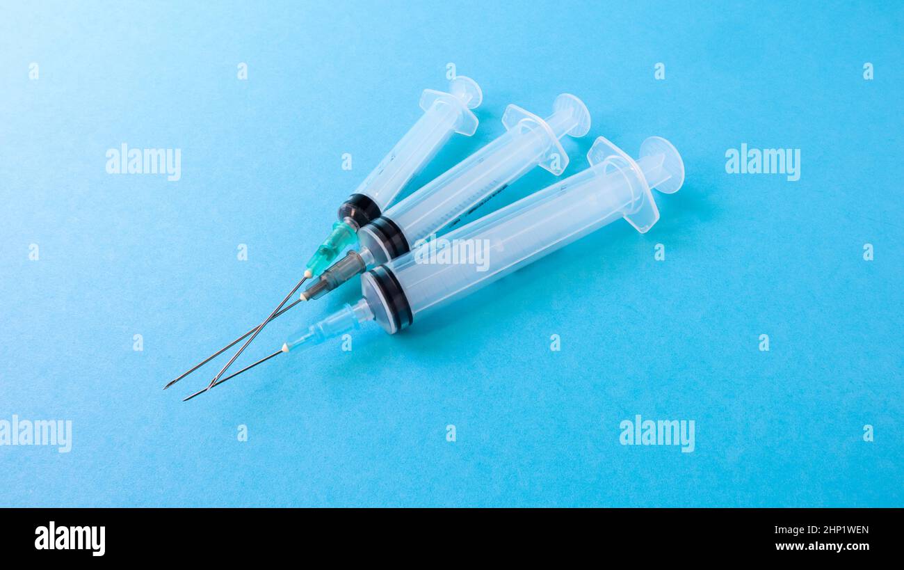 Three medical disposable plastic empty syringes with needles of ...