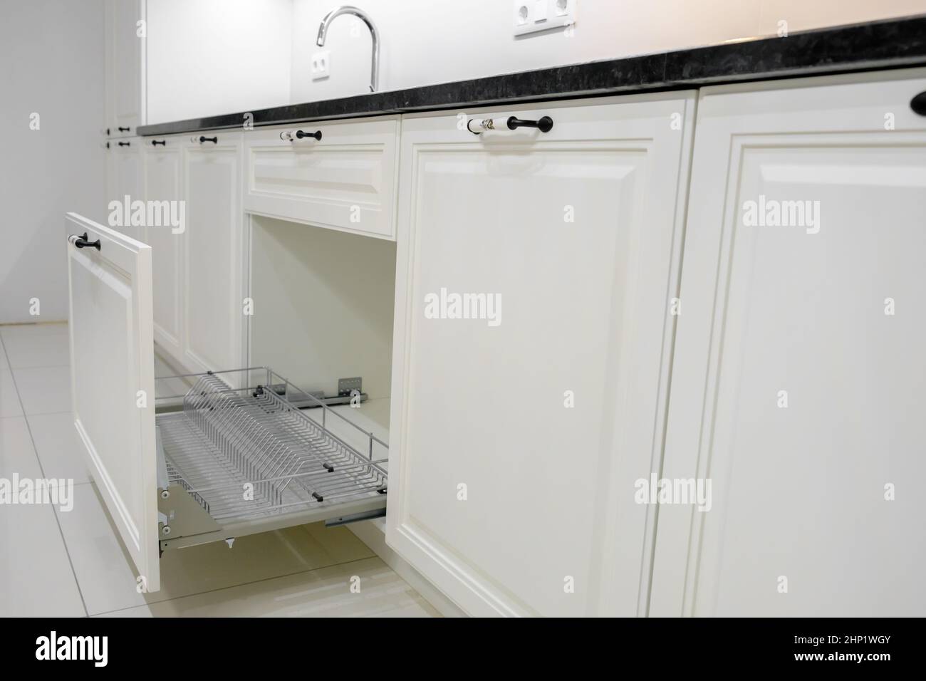 Side view modern and elegant kitchen with white drawers, open kitchen ...