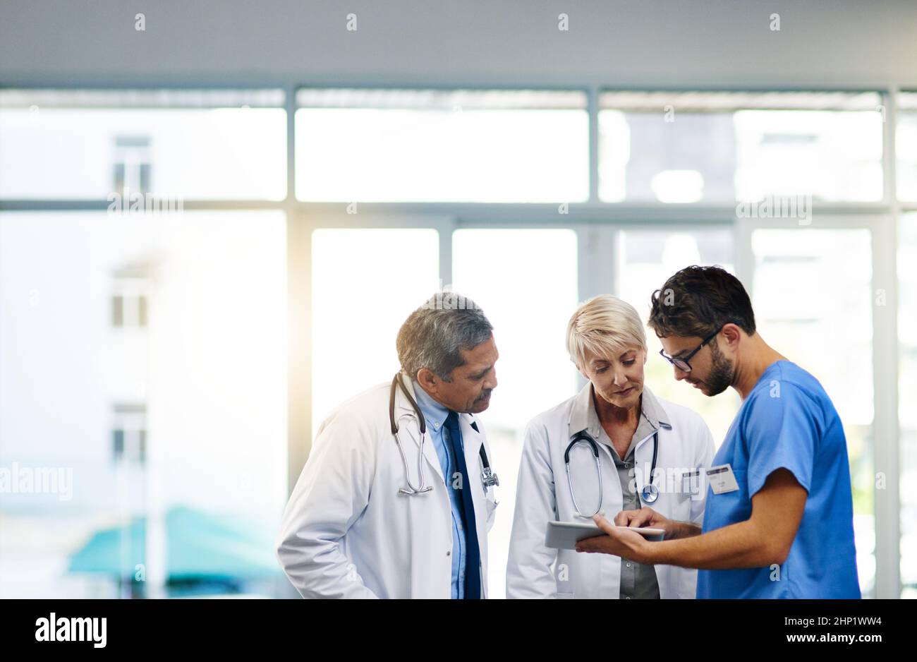 Smart doctors use smart apps. Shot of a team of doctors using a digital ... Smart doctors use smart apps. Shot of a team of doctors using a digital ...