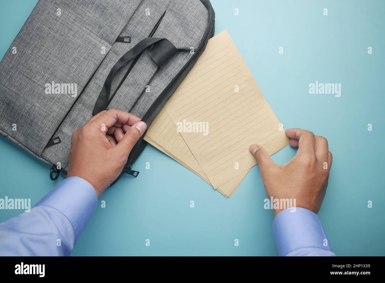 putting paper in a bag on table Stock Photo - Alamy