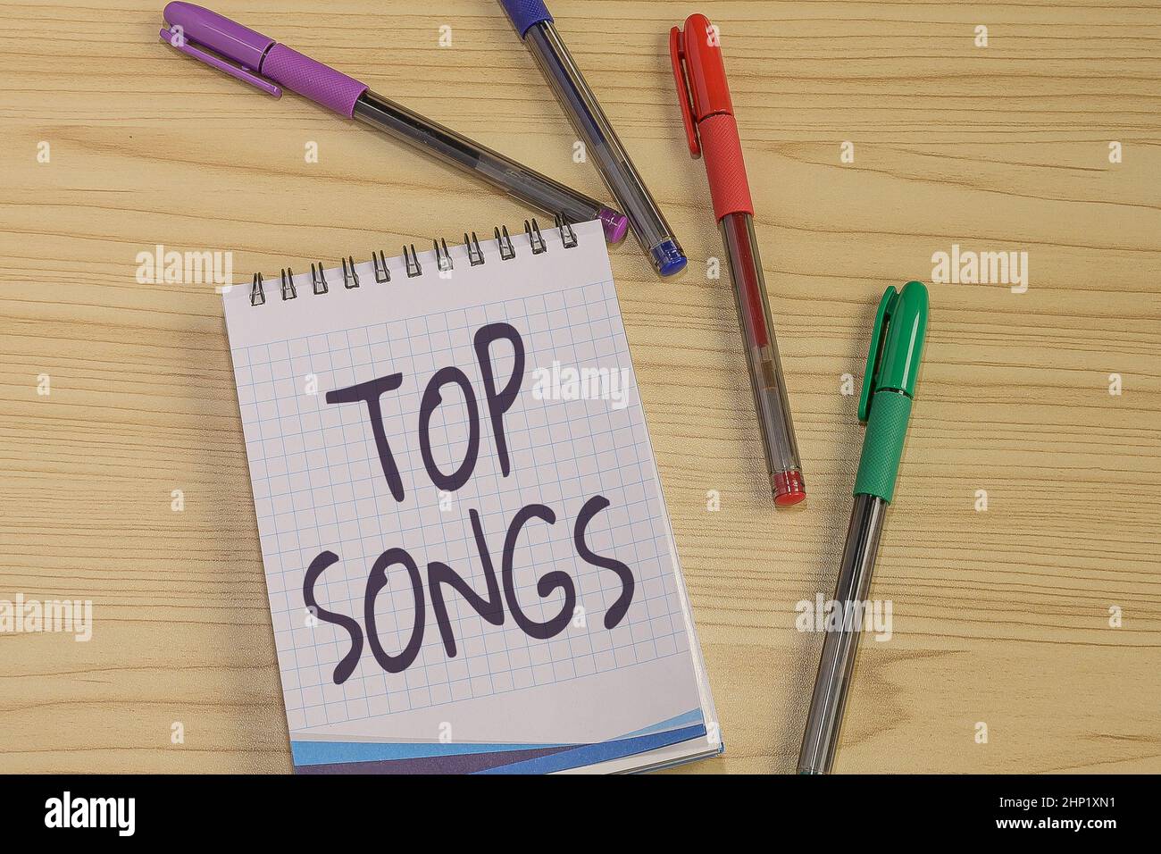 Sign displaying Top Songs, Word Written on recorded song that becomes ...