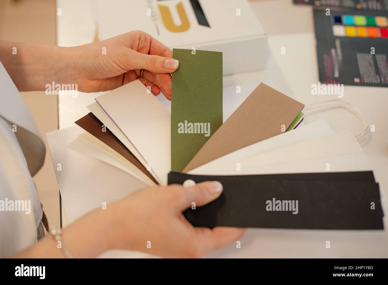 Cropped photo of woman hands holding choosing design multicolor folded ...