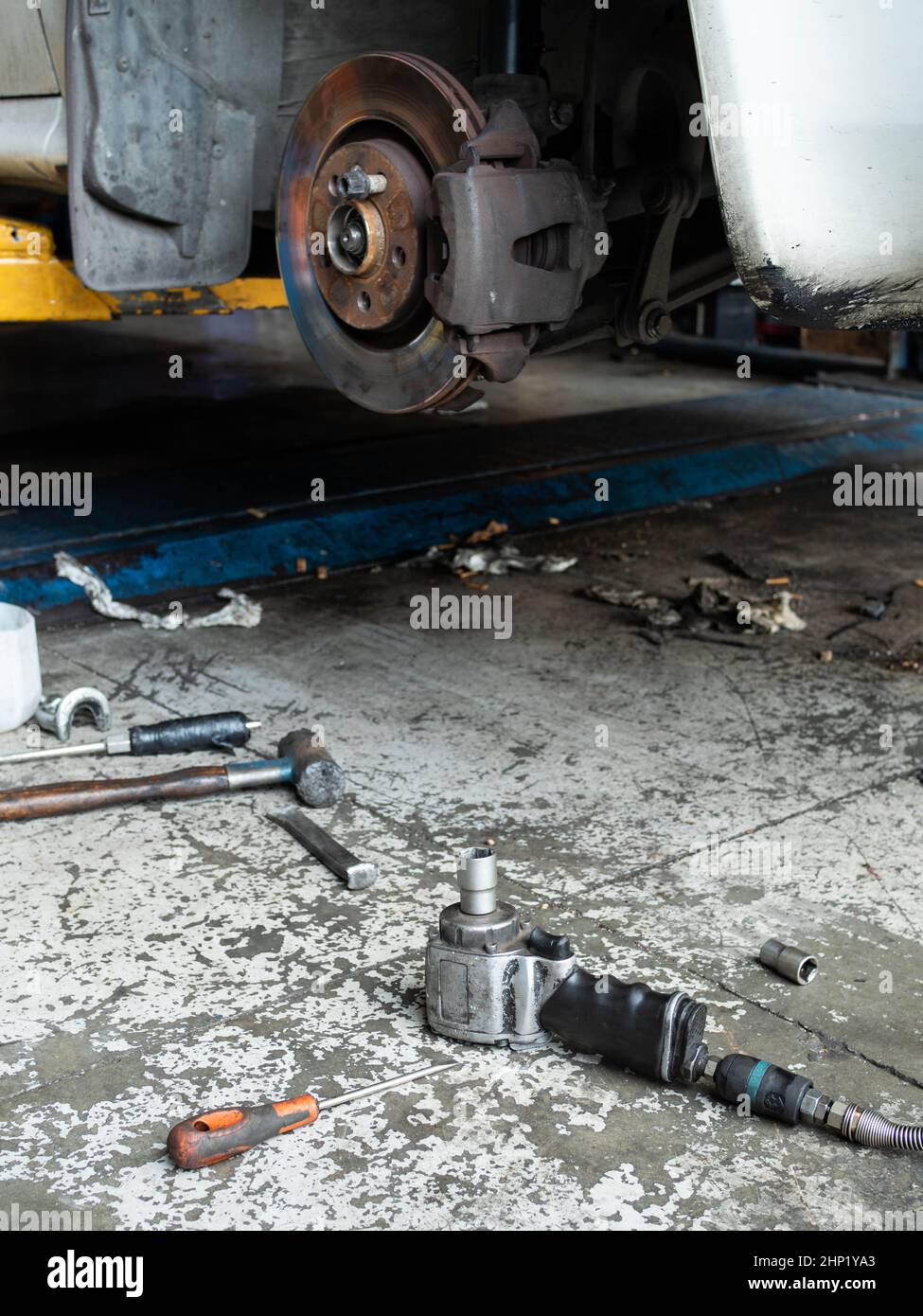 Real life dirty mechanical workshop. Detail of disassembled car and ...