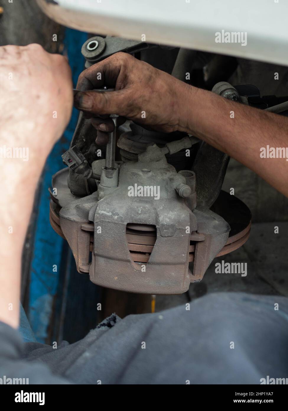 Concept: Auto mechanic. Worker repairing car brakes. Hand detail Stock ...