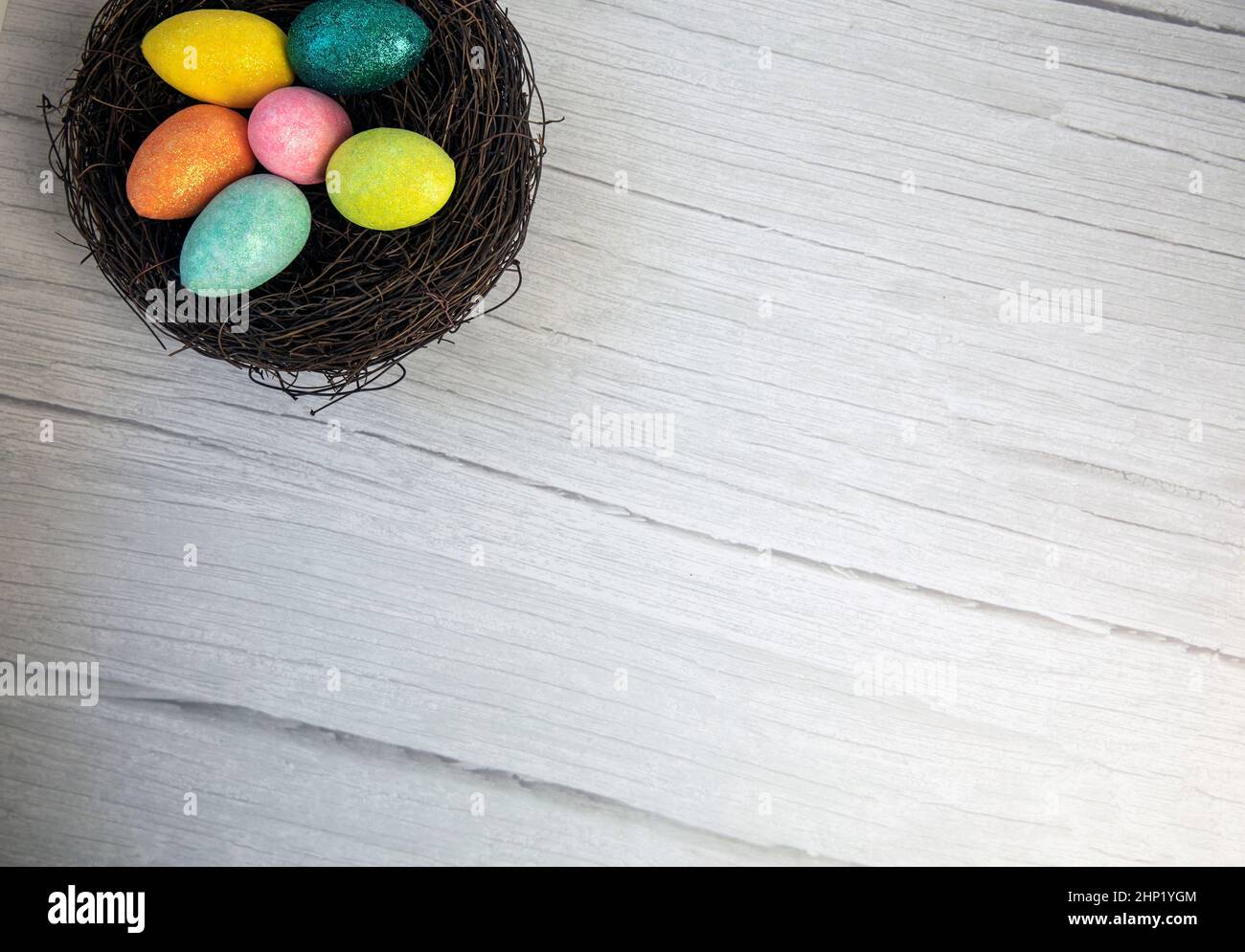Colorful Easter Egg Nest with Extra White or Gray Wood Board Background ...