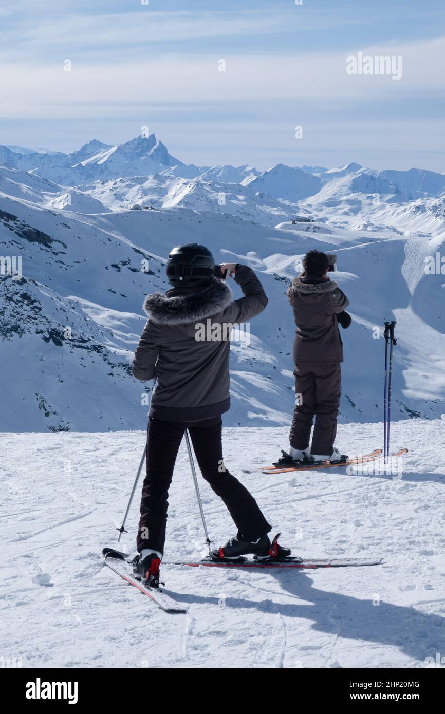 Skiers admiring the view from the top of Mt Vallon, Méribel Stock Photo ...